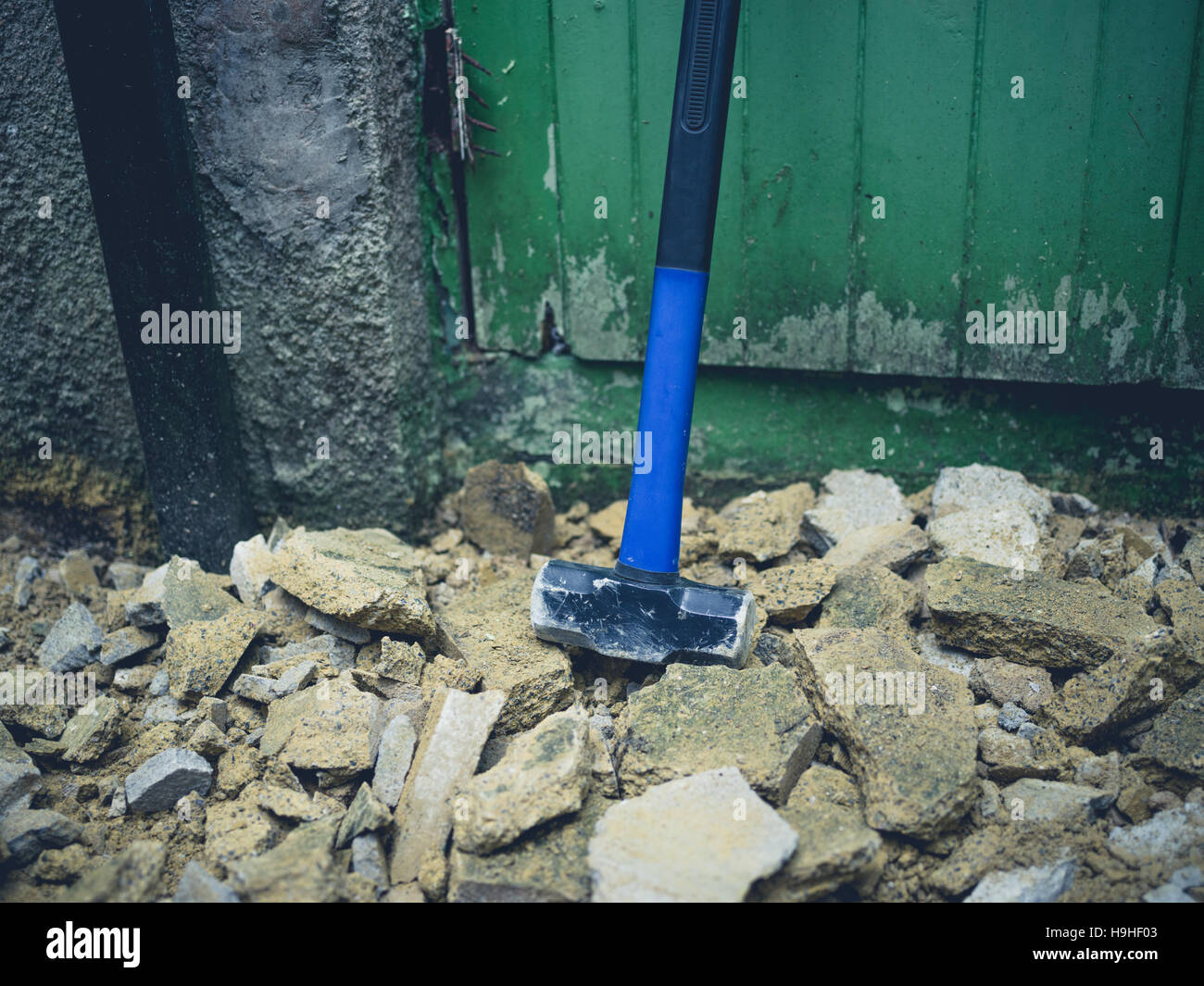 A sledge hammer and rubble outside Stock Photo - Alamy