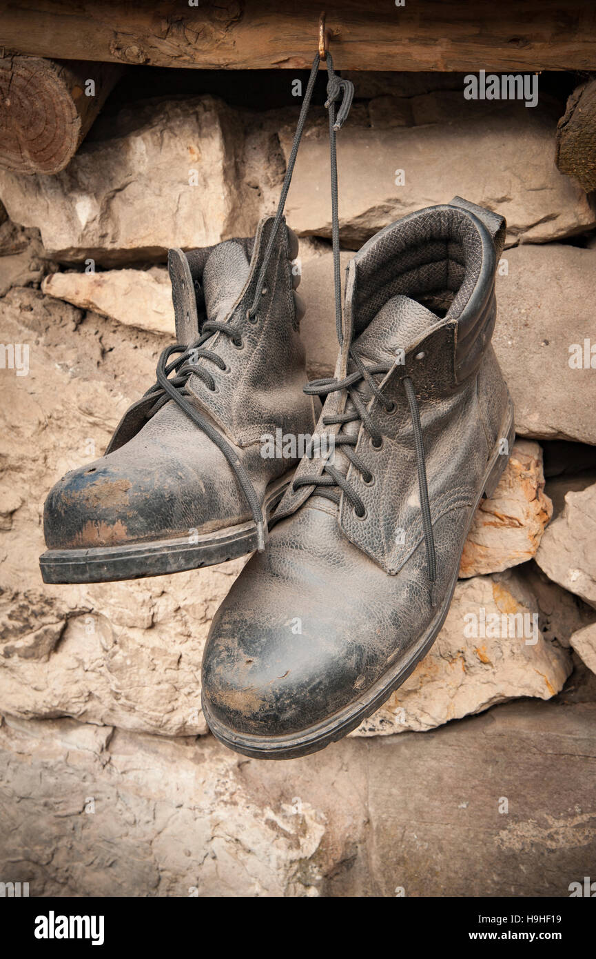Old boots hanging by laces Stock Photo - Alamy