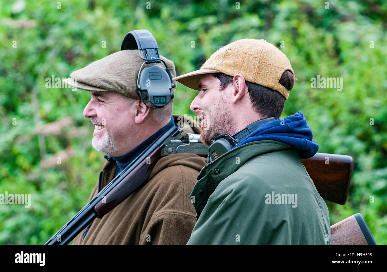 Two men with shotguns chatting during a days shooting in England, on a ...