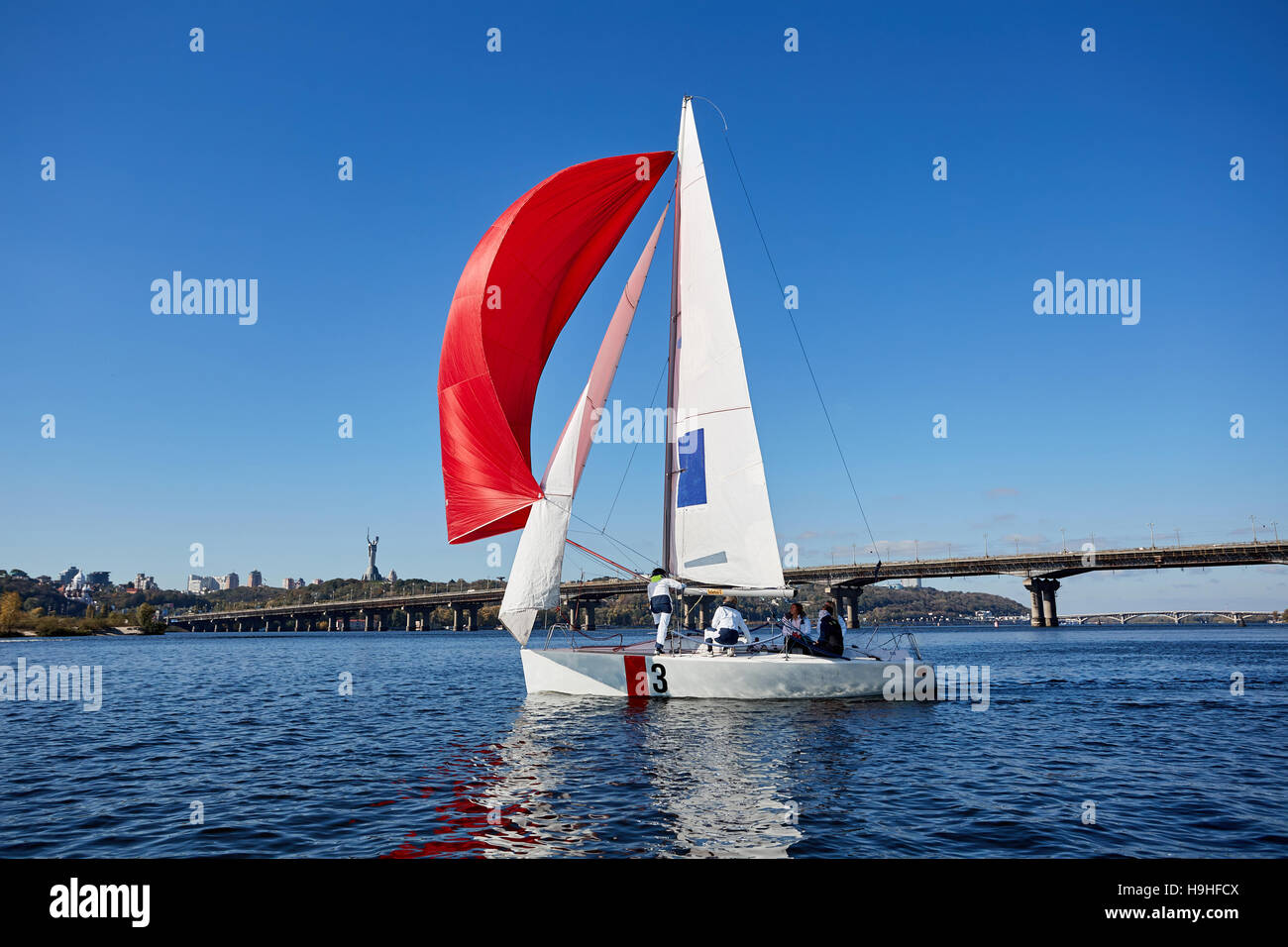 Sailing man on sailboat during regatta Stock Photo - Alamy