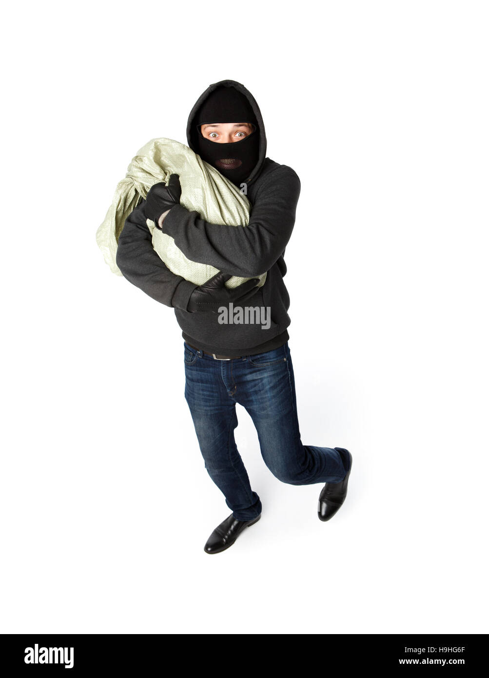 Robber hugging sack of money Stock Photo - Alamy