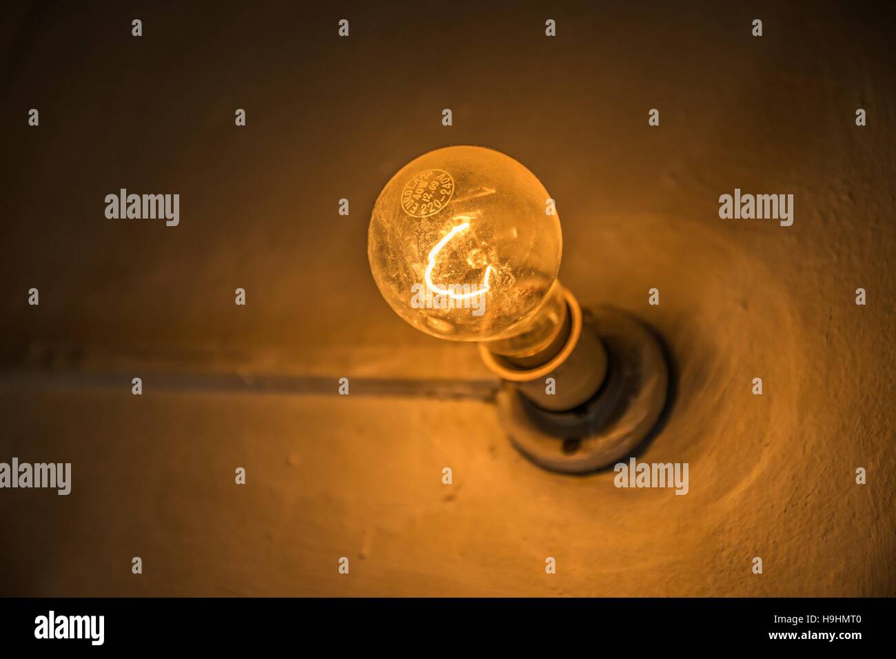 Old dusty light bulb glowing Stock Photo - Alamy