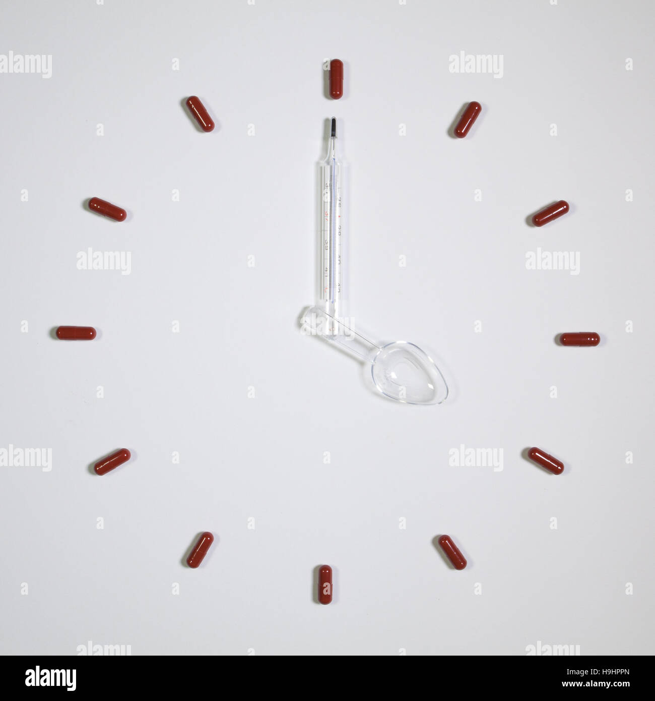 Time - Clock of twelve pills, medical thermometer and plastic spoon ...