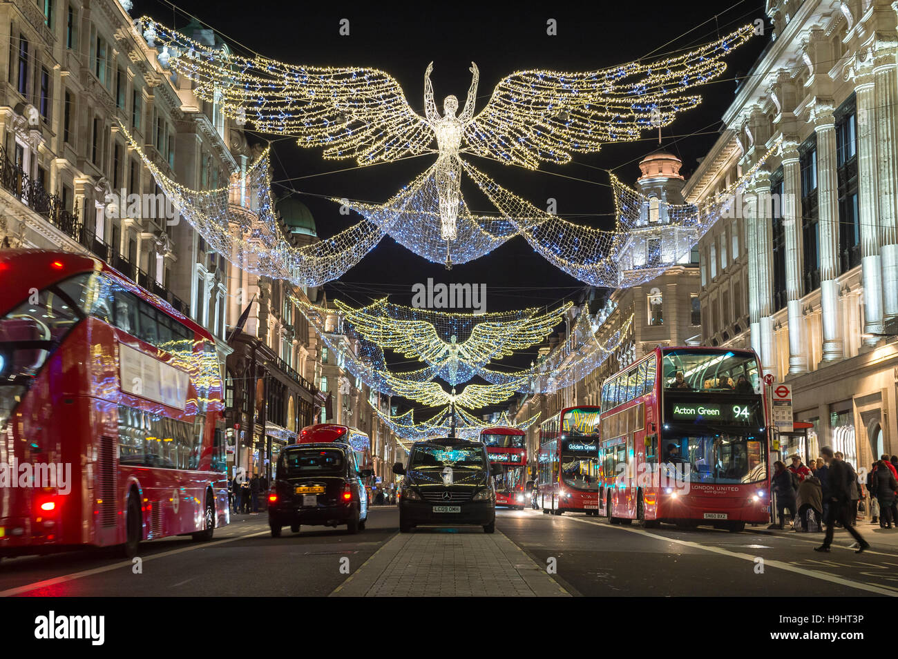 LONDON - NOVEMBER 18, 2016: Red double-decker bus pass under twinkling ...