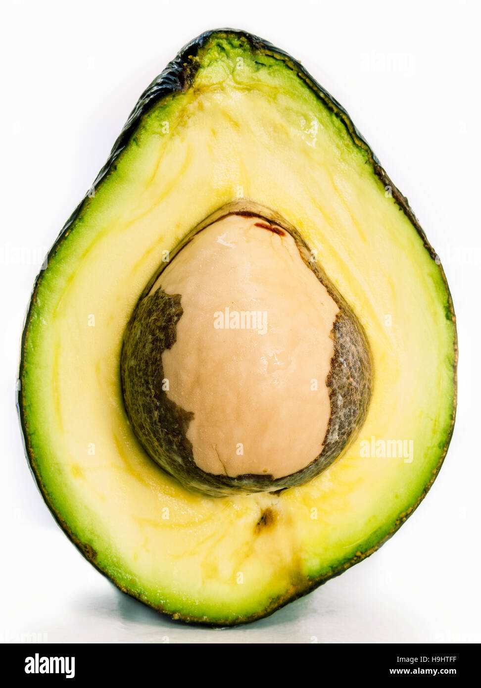 Halved avocado with core isolated on white - in macro shot Stock Photo ...