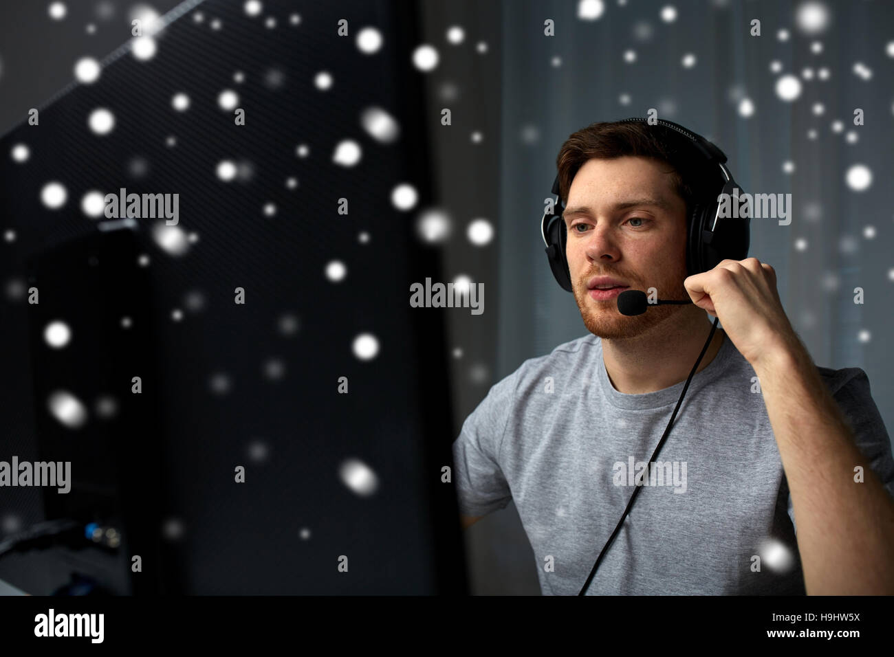 man in headset playing computer video game at home Stock Photo - Alamy
