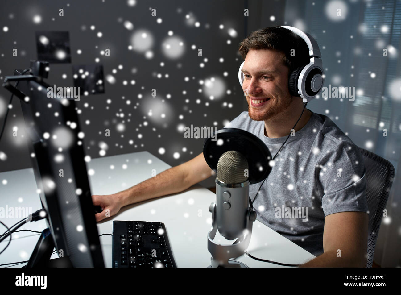 man in headset playing computer video game at home Stock Photo - Alamy