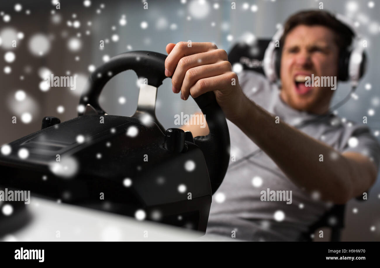 man playing car racing video game with wheel Stock Photo - Alamy