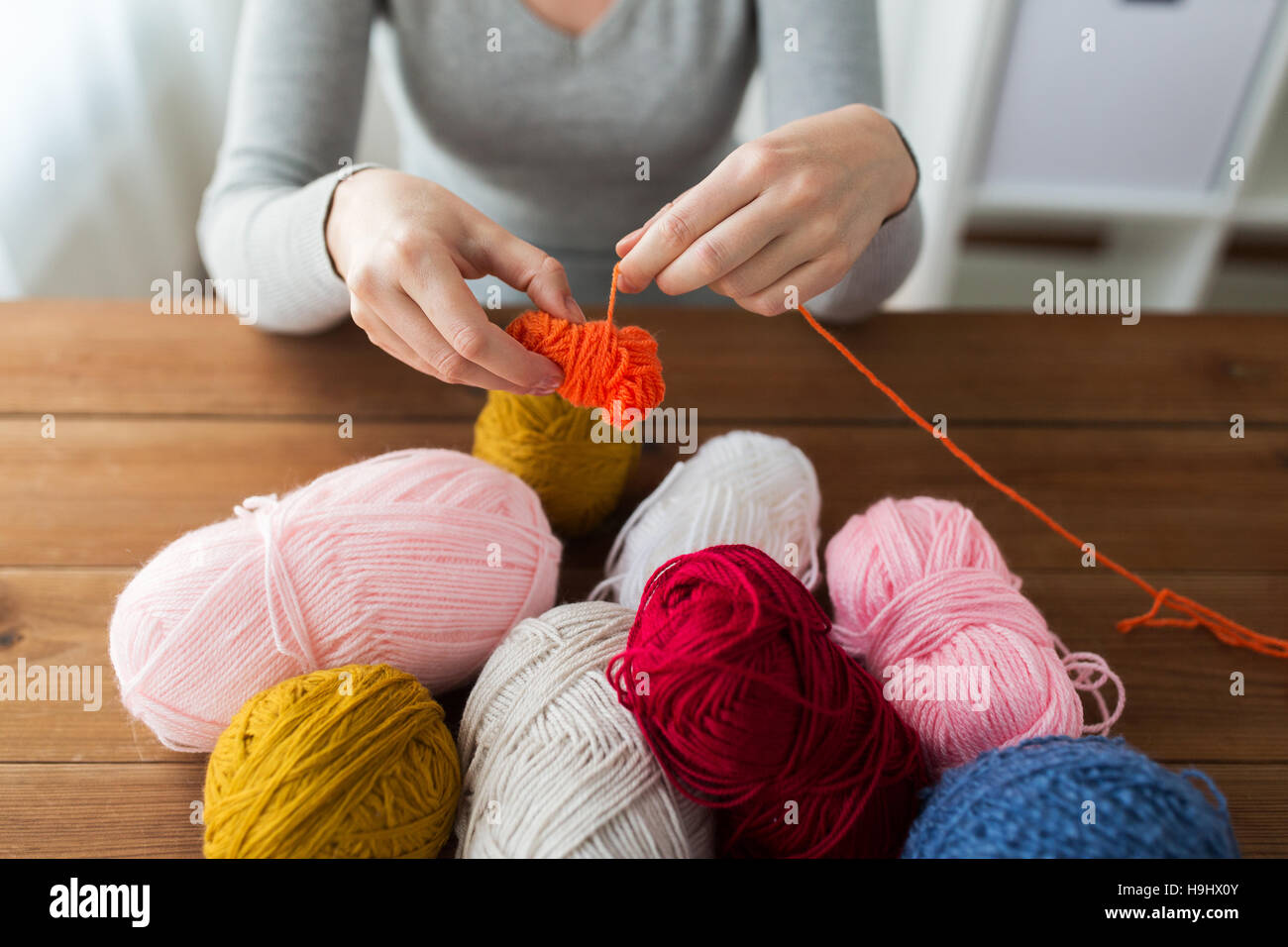 woman pulling yarn up into ball Stock Photo - Alamy