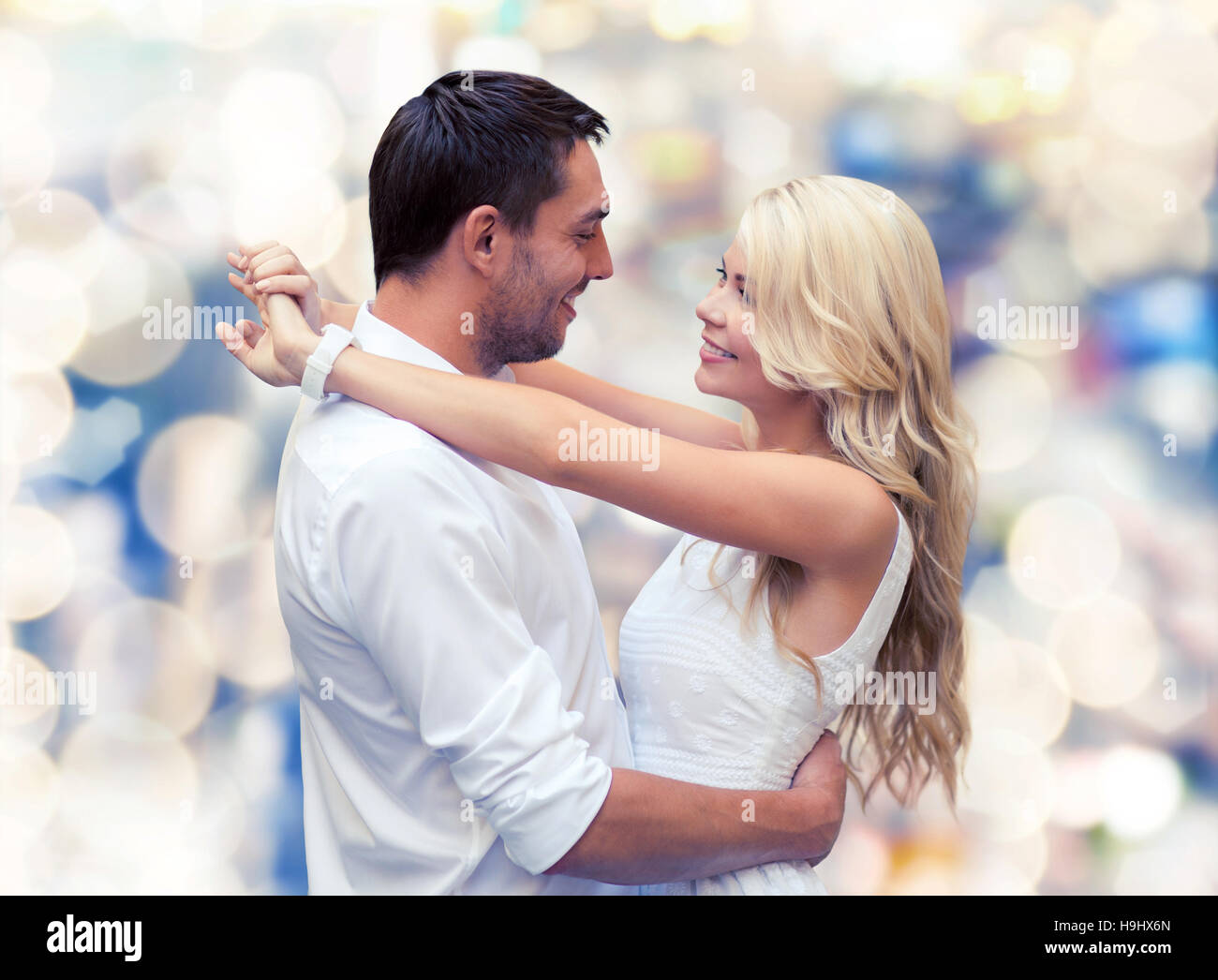 happy couple hugging over lights background Stock Photo - Alamy