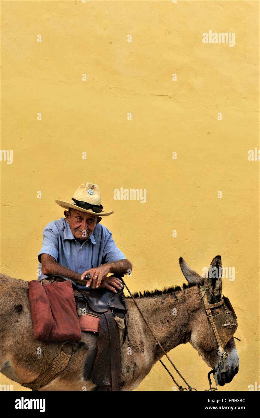 Man on donkey on the streets of Trinidad in Cuba Stock Photo - Alamy