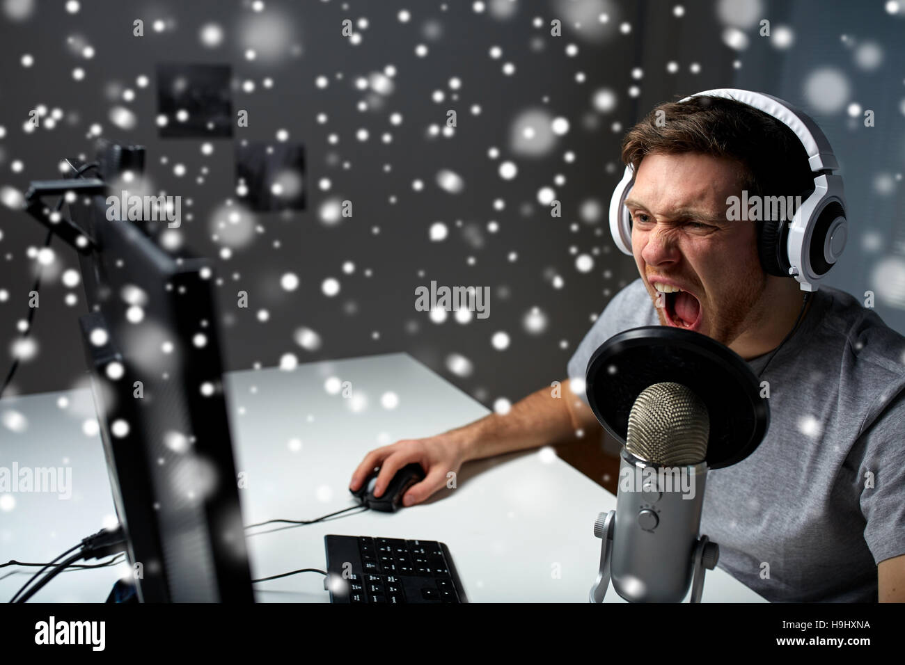man in headset playing computer video game at home Stock Photo - Alamy