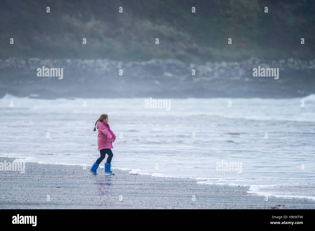 A young girl dancing on her own on Fistral Beach in Newquay, Cornwall ...