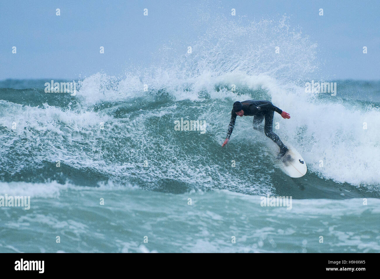 A surfer in spectacular action at Fistral Beach in Newquay, Cornwall ...
