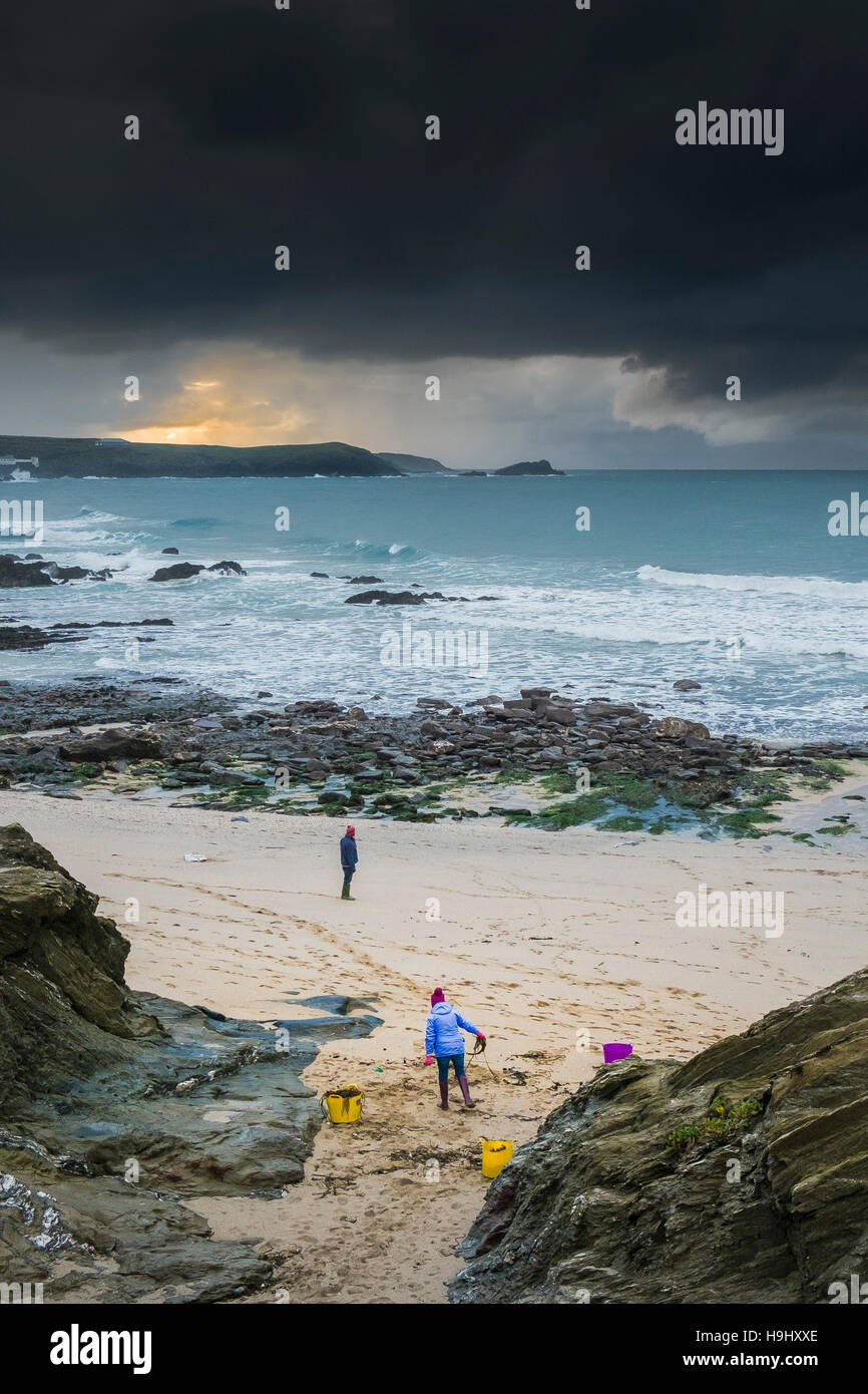 Storm Angus approaching Little Fistral as two people gather seaweed on ...