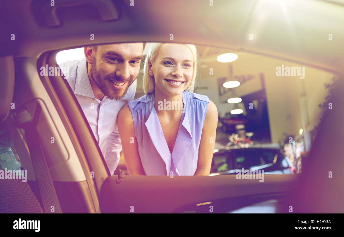 happy couple buying car in auto show or salon Stock Photo - Alamy