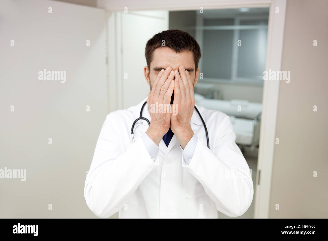 sad or crying male doctor at hospital ward Stock Photo - Alamy