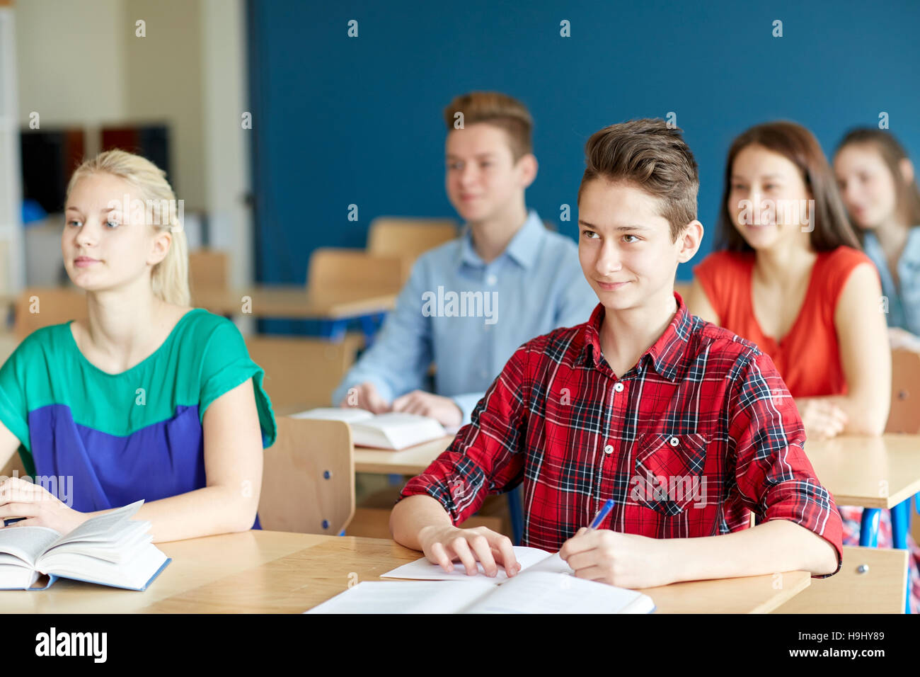group of students with notebooks at school lesson Stock Photo - Alamy