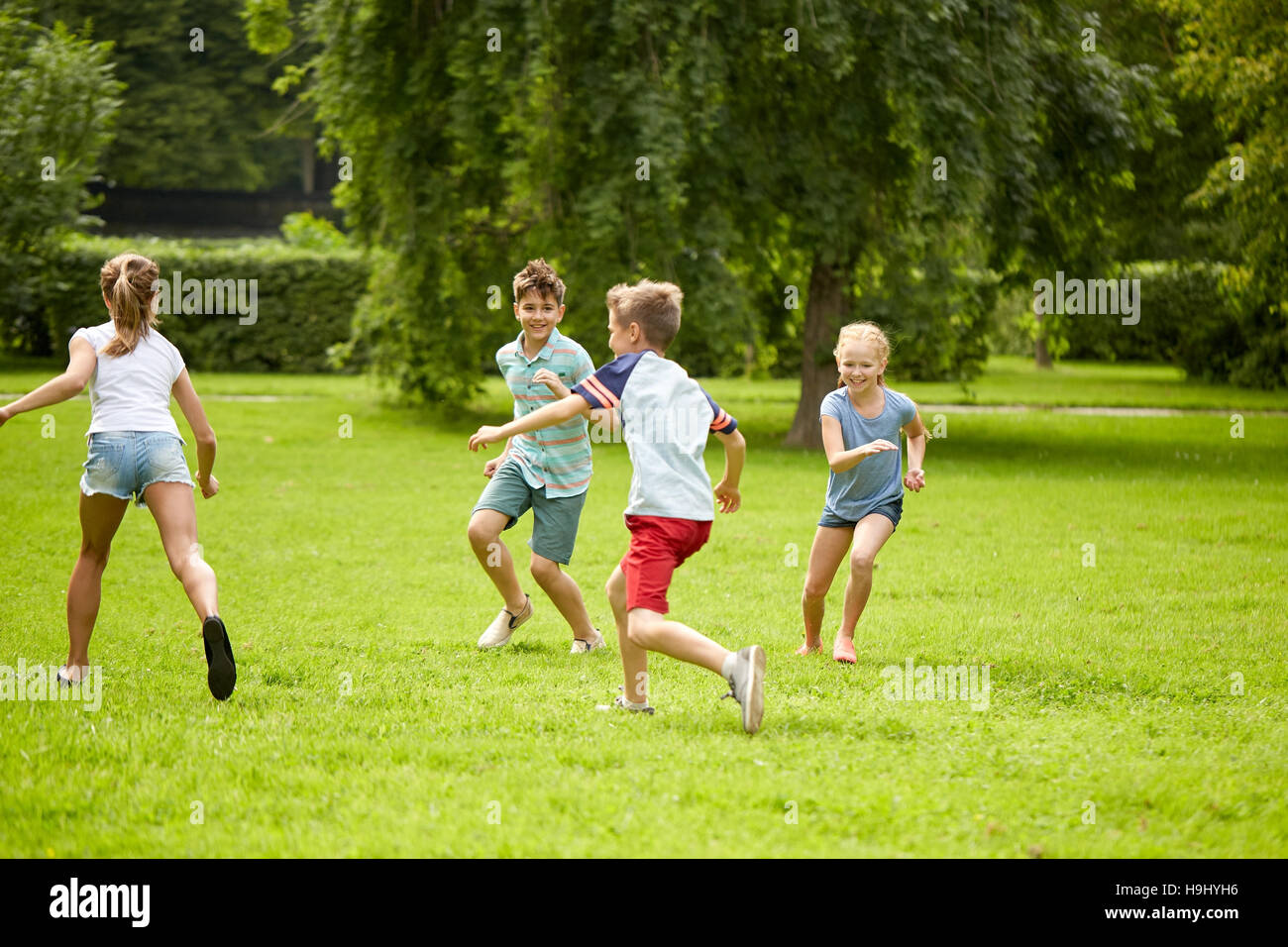 happy kids running and playing game outdoors Stock Photo - Alamy