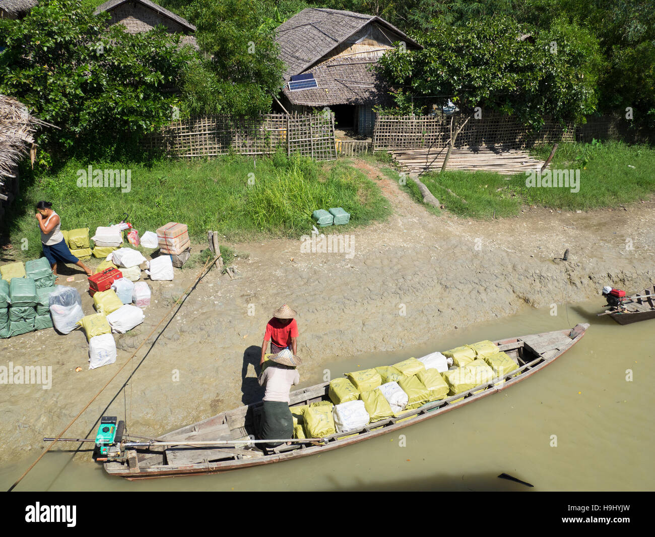 Goods being loaded onto a small boat for local distribution along the ...