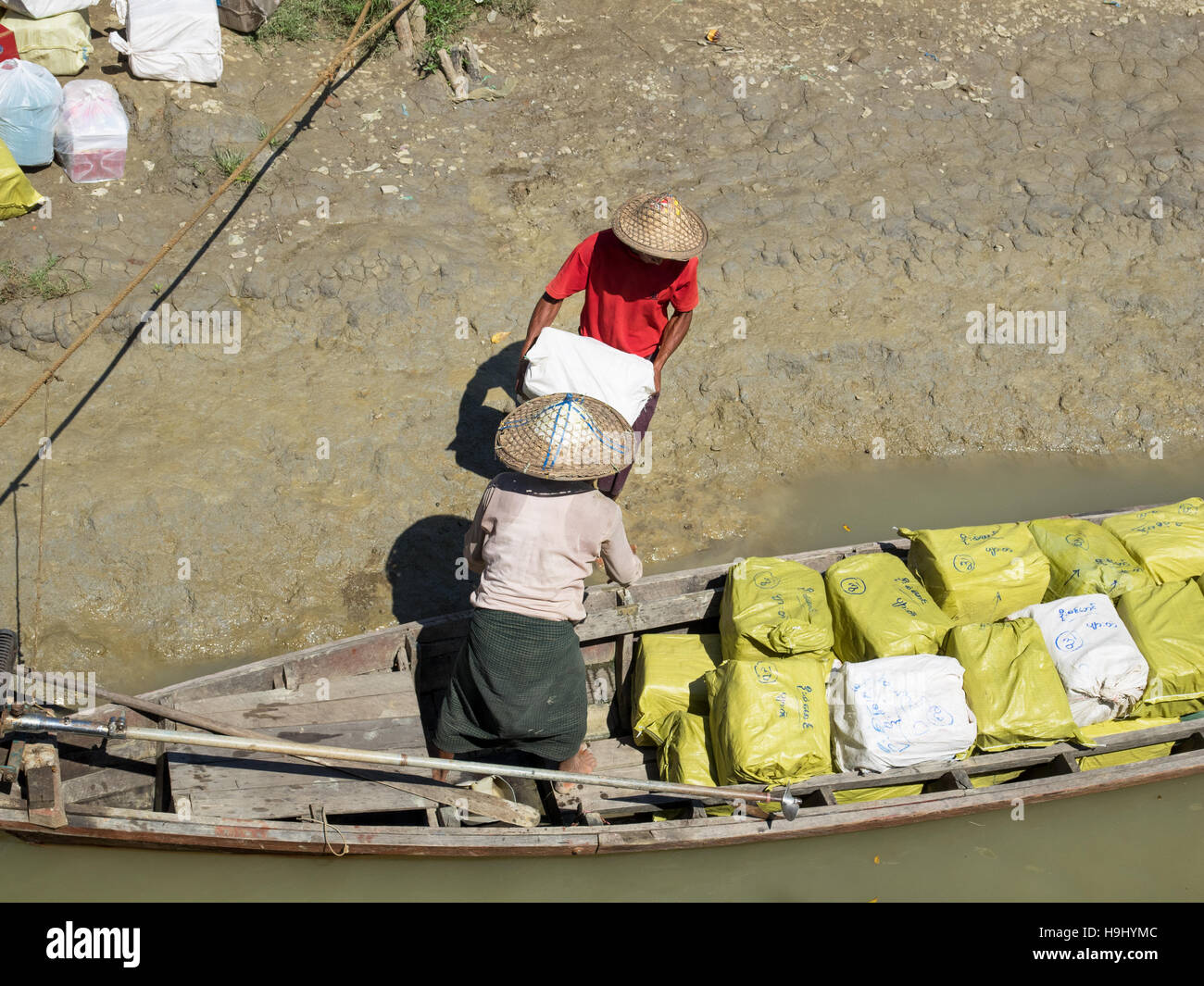 Goods being loaded onto a small boat for local distribution along the ...