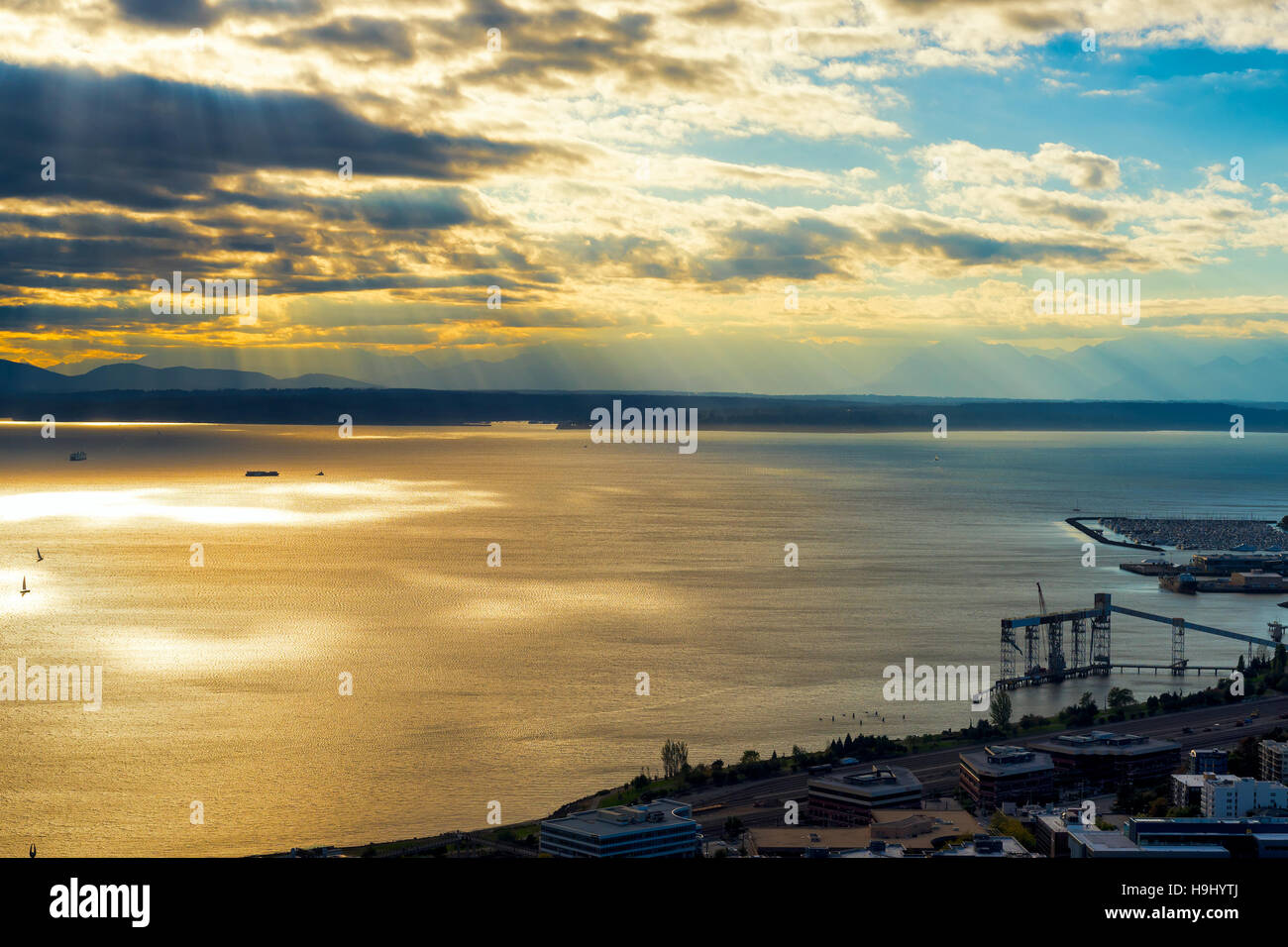 Aerial view of Puget Sound at Seattle lit up by sun rays, with Olympic ...