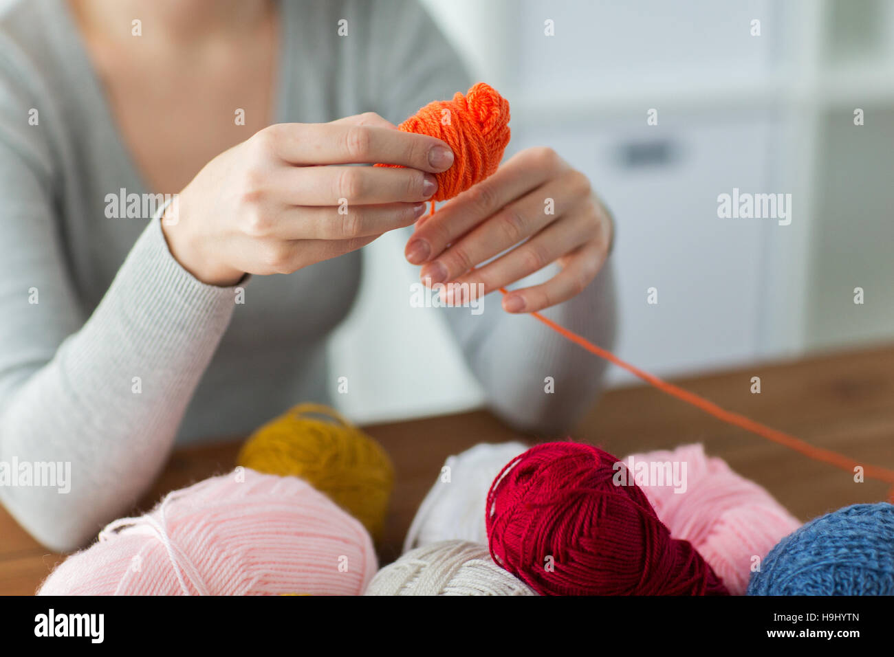 woman pulling yarn up into ball Stock Photo - Alamy