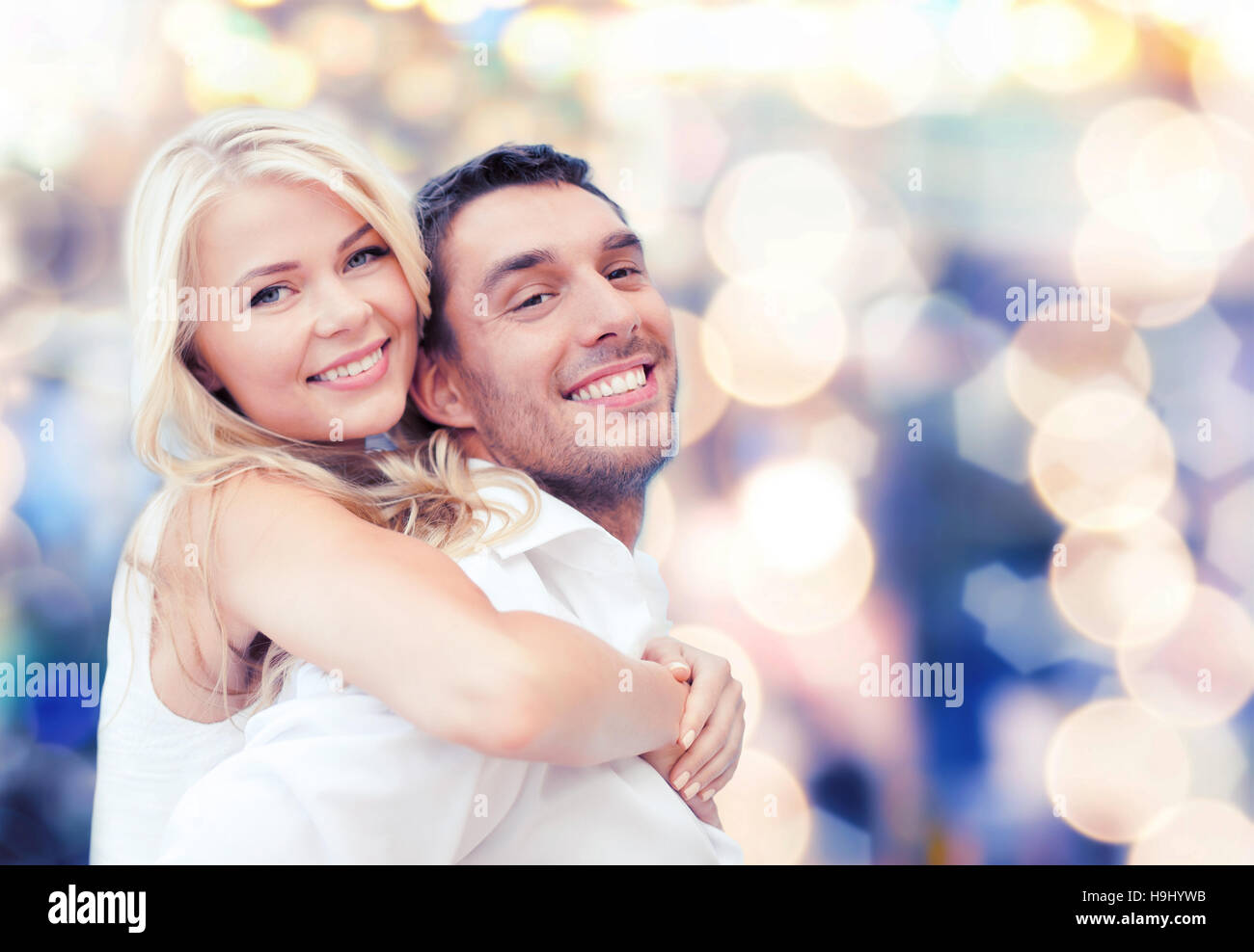 happy couple having fun over lights background Stock Photo - Alamy
