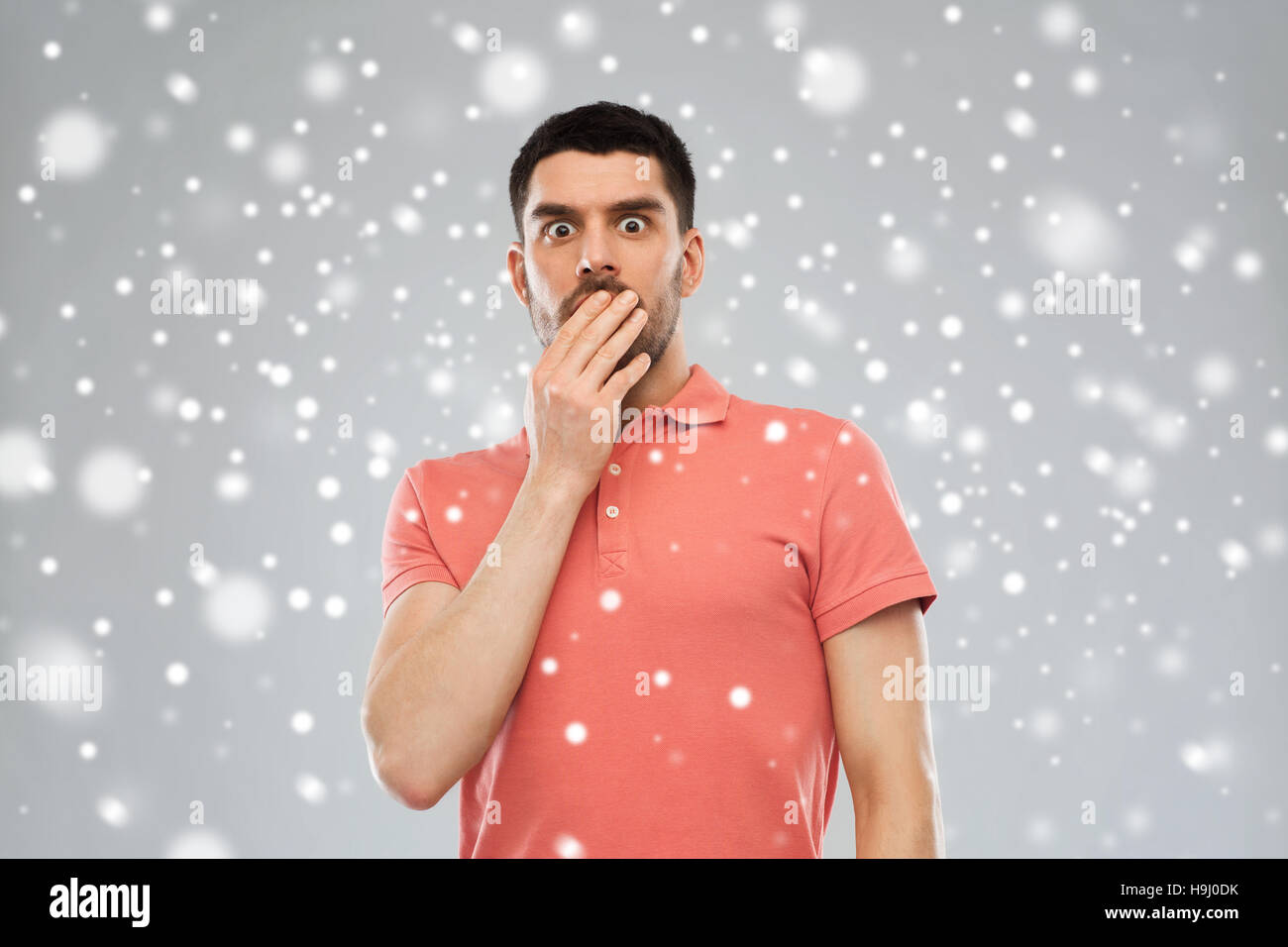 scared man in polo t-shirt over snow Stock Photo - Alamy