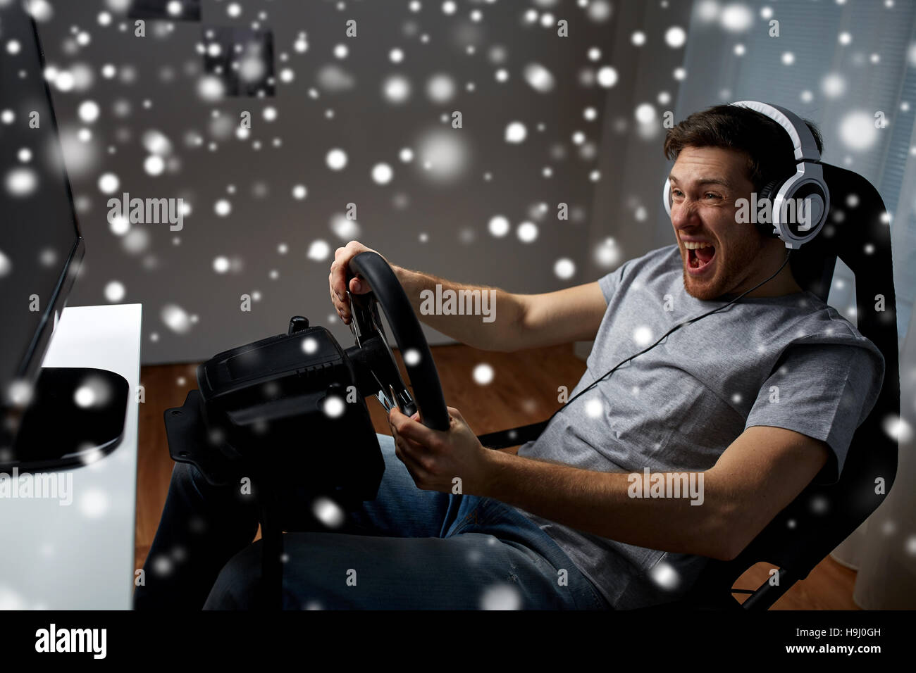 man playing car racing video game at home Stock Photo - Alamy