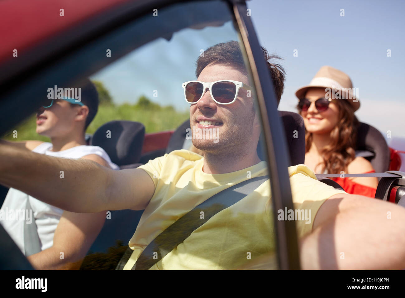 happy friends driving in cabriolet car Stock Photo - Alamy