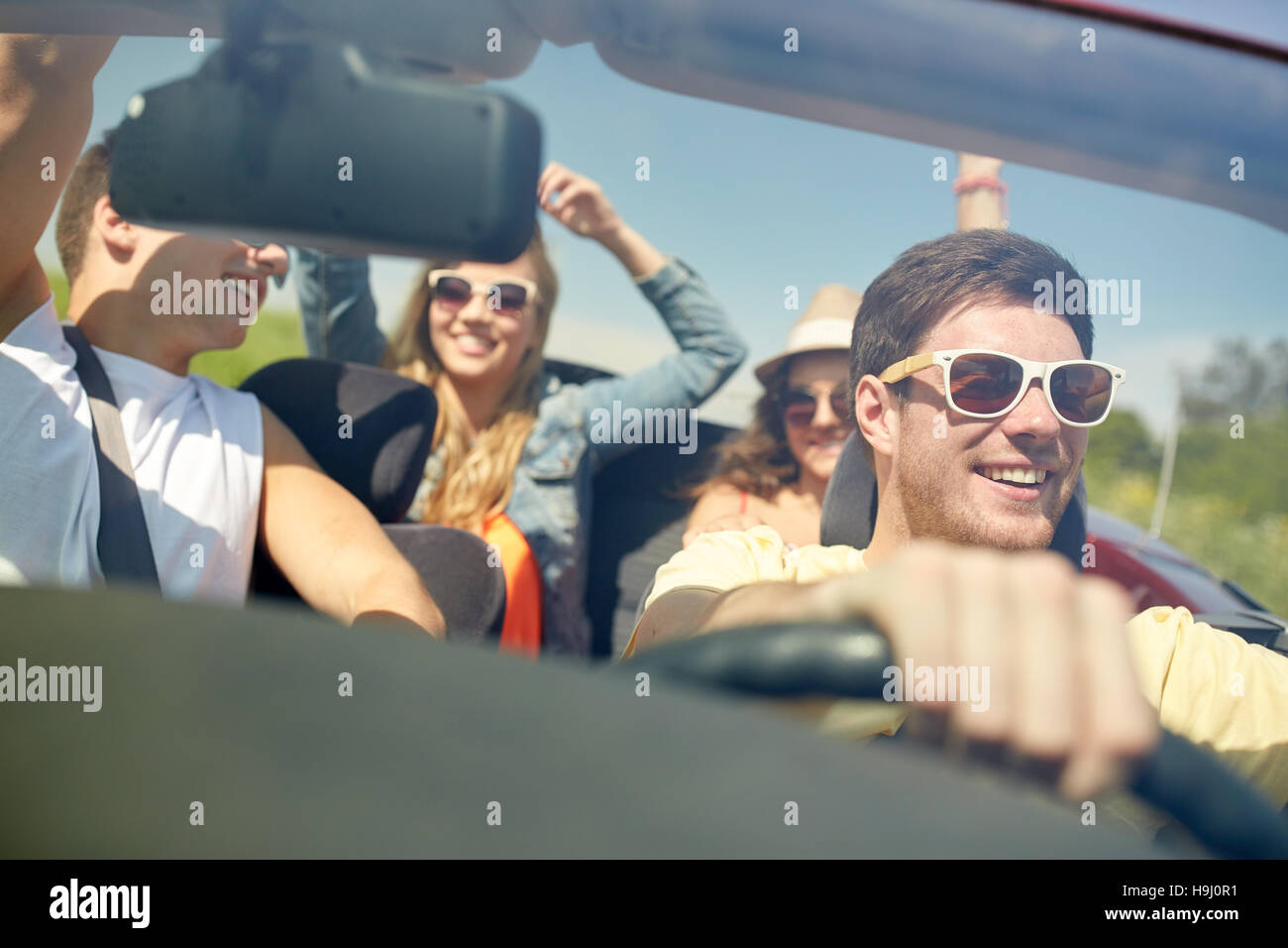 happy friends driving in cabriolet car Stock Photo - Alamy