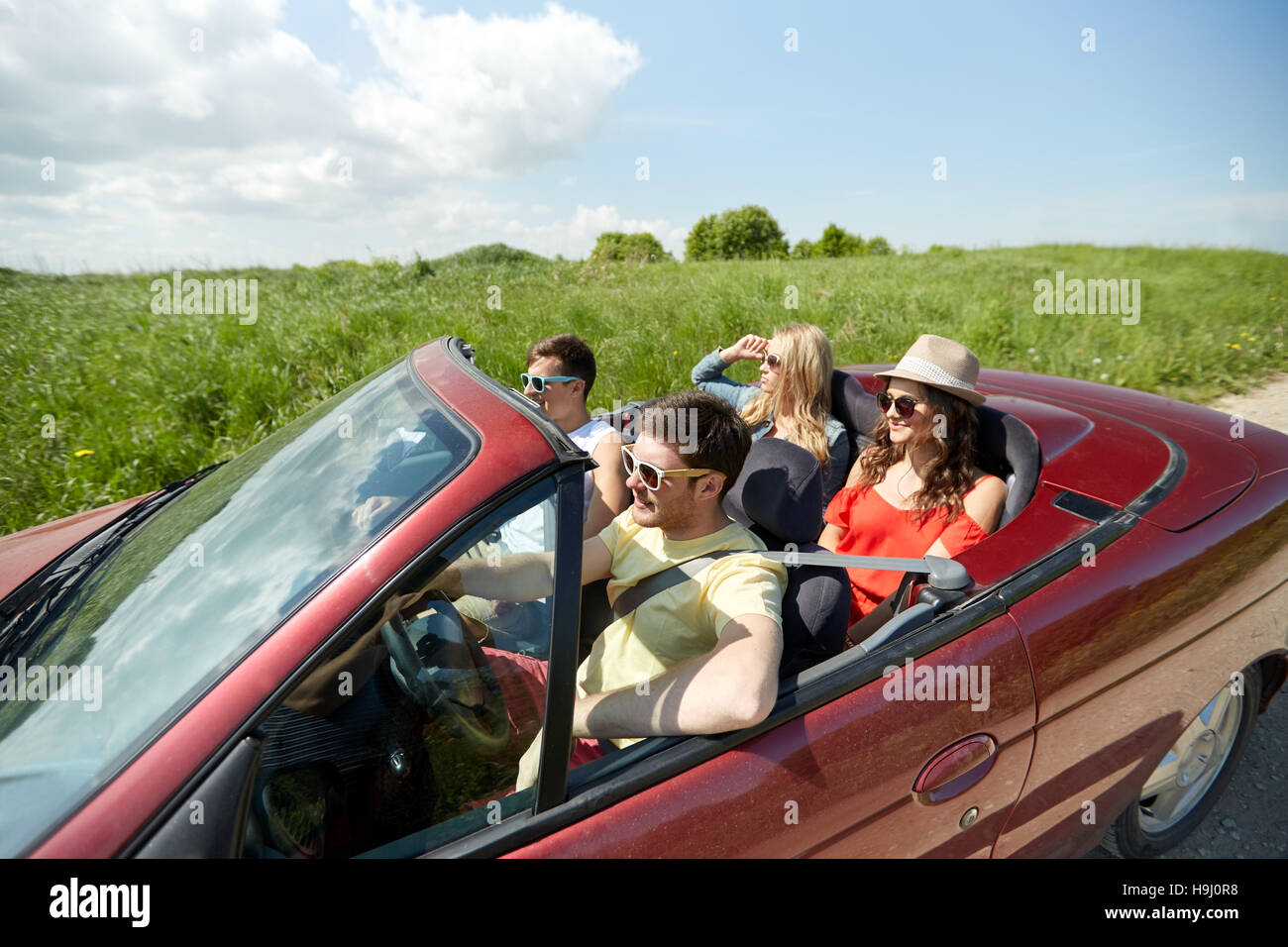 happy friends driving in cabriolet car at country Stock Photo - Alamy