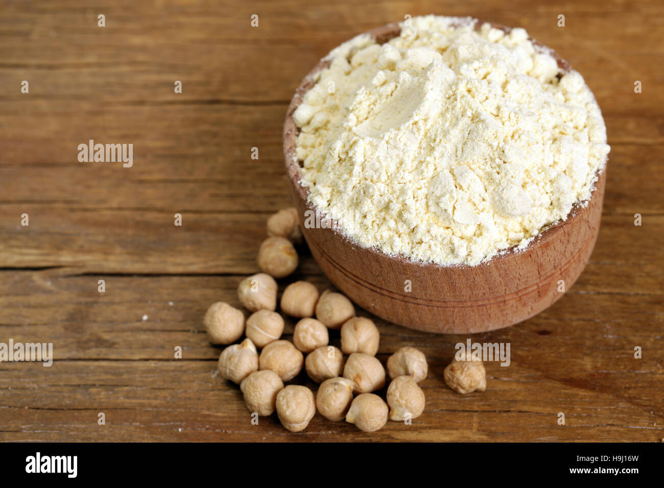 Natural organic chick pea flour in a wooden bowl Stock Photo - Alamy