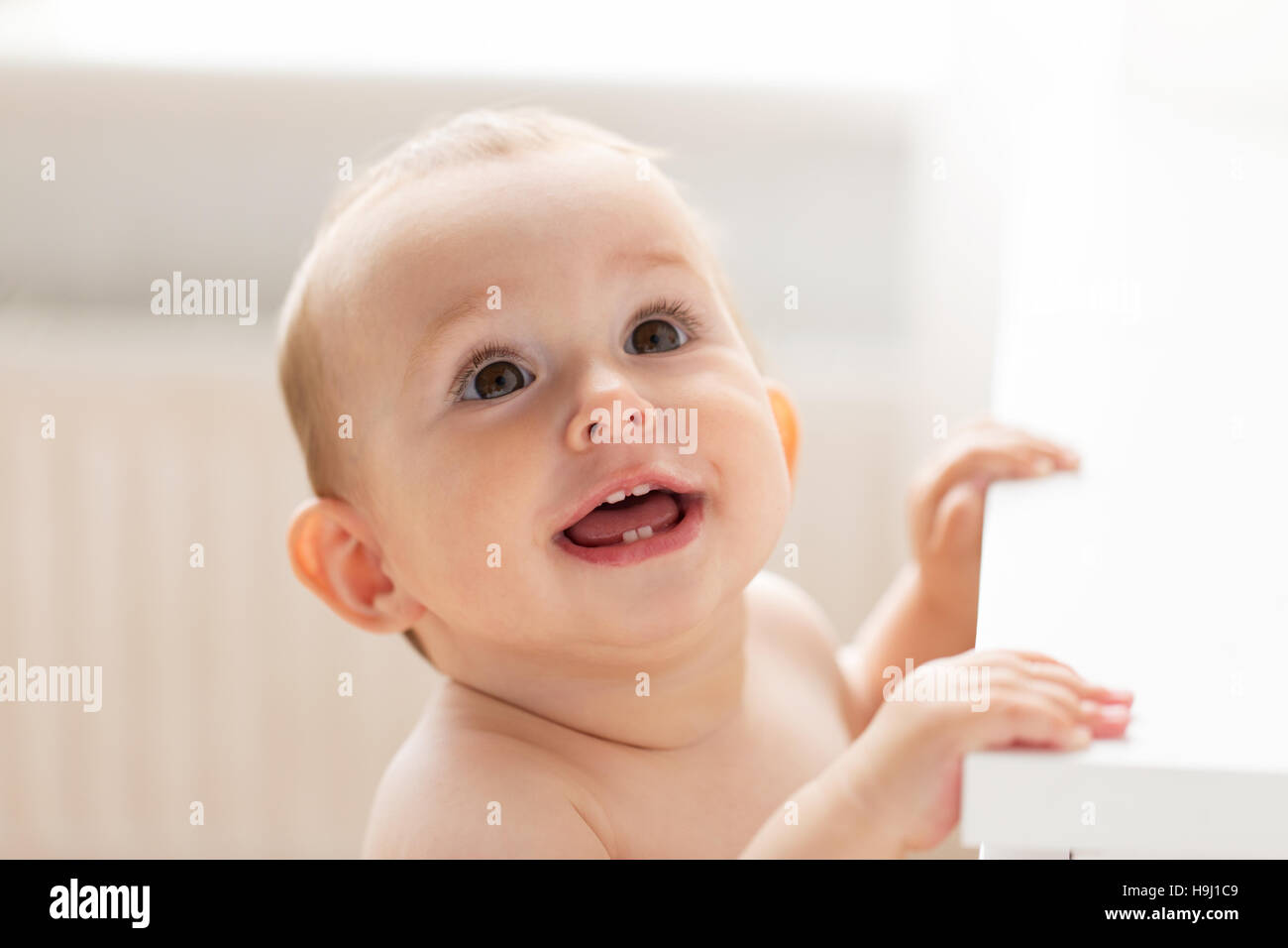 happy little baby boy or girl at home looking up Stock Photo - Alamy