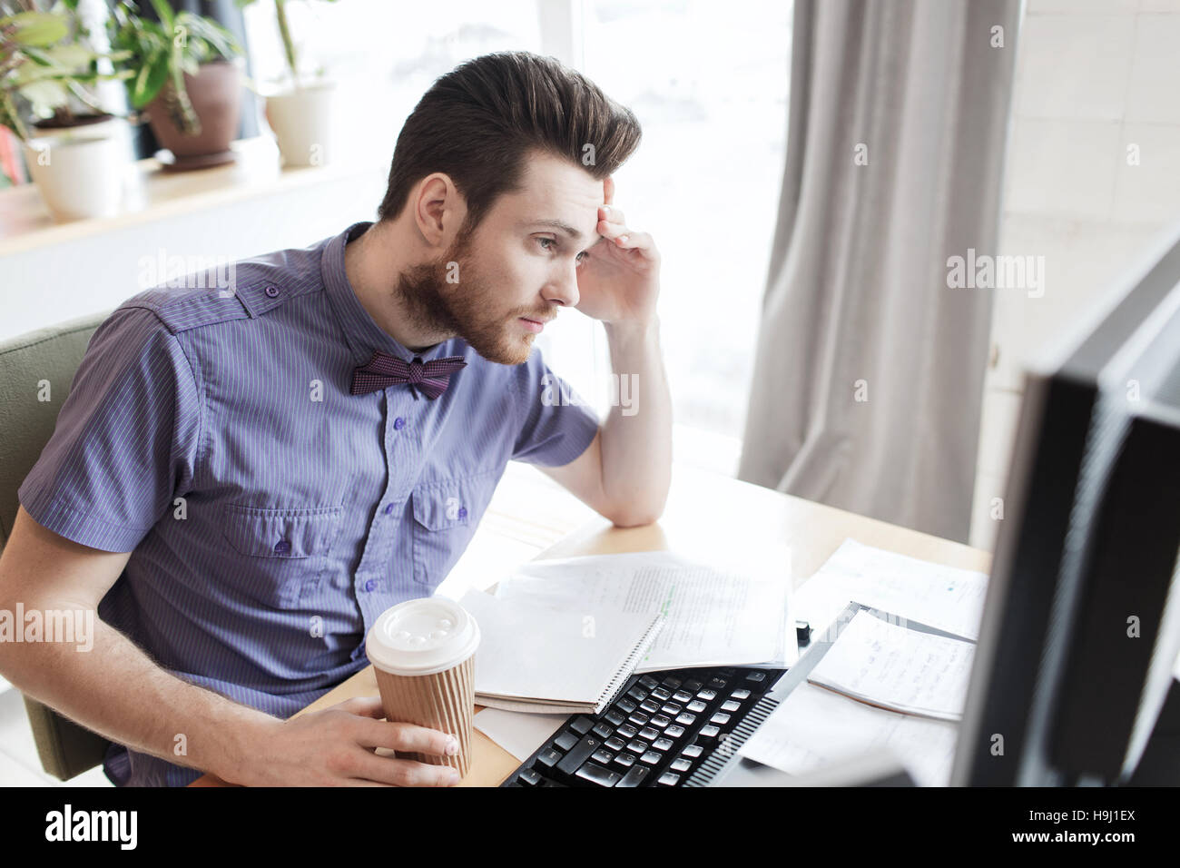 creative male worker with computer drinking coffee Stock Photo - Alamy