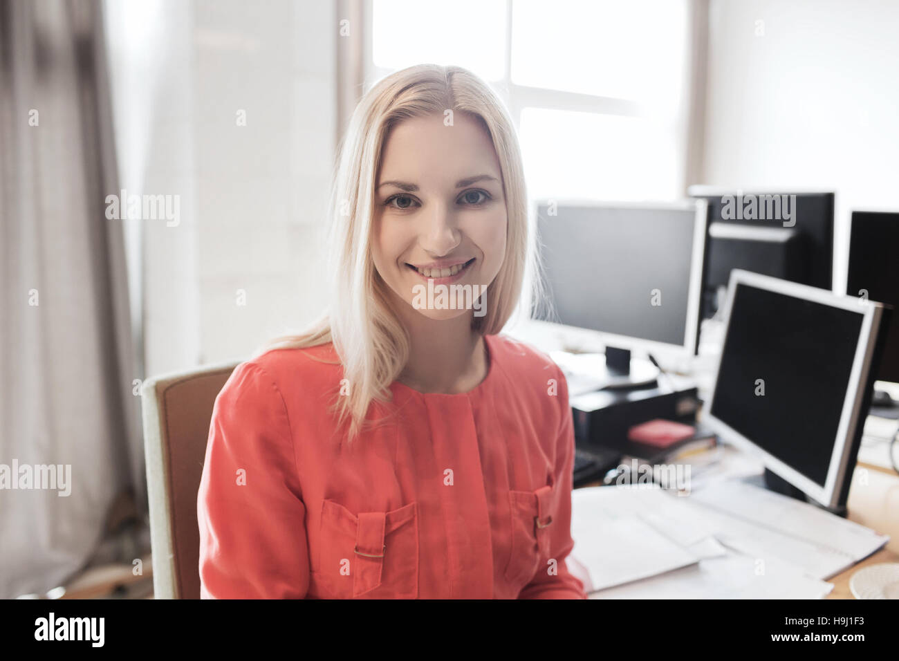 happy creative female office worker with computers Stock Photo - Alamy