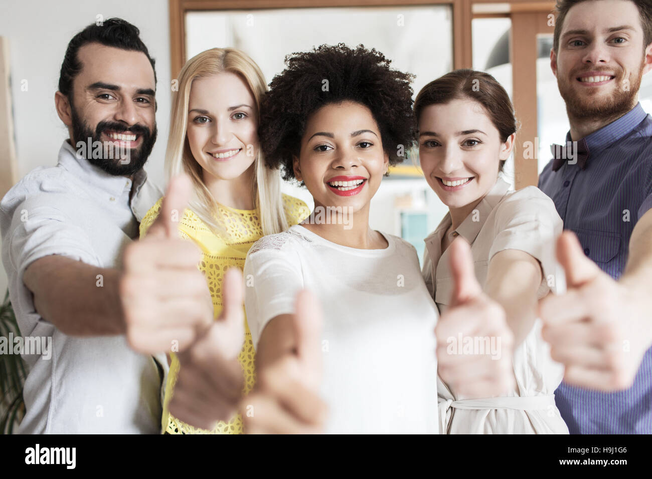 Happy students showing thumbs up hi-res stock photography and images ...