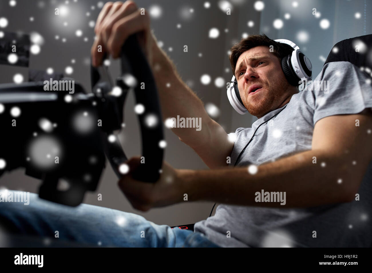 man playing car racing video game at home Stock Photo - Alamy