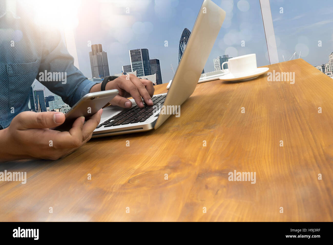 designer hand working and smart phone and laptop on wooden desk Stock ...