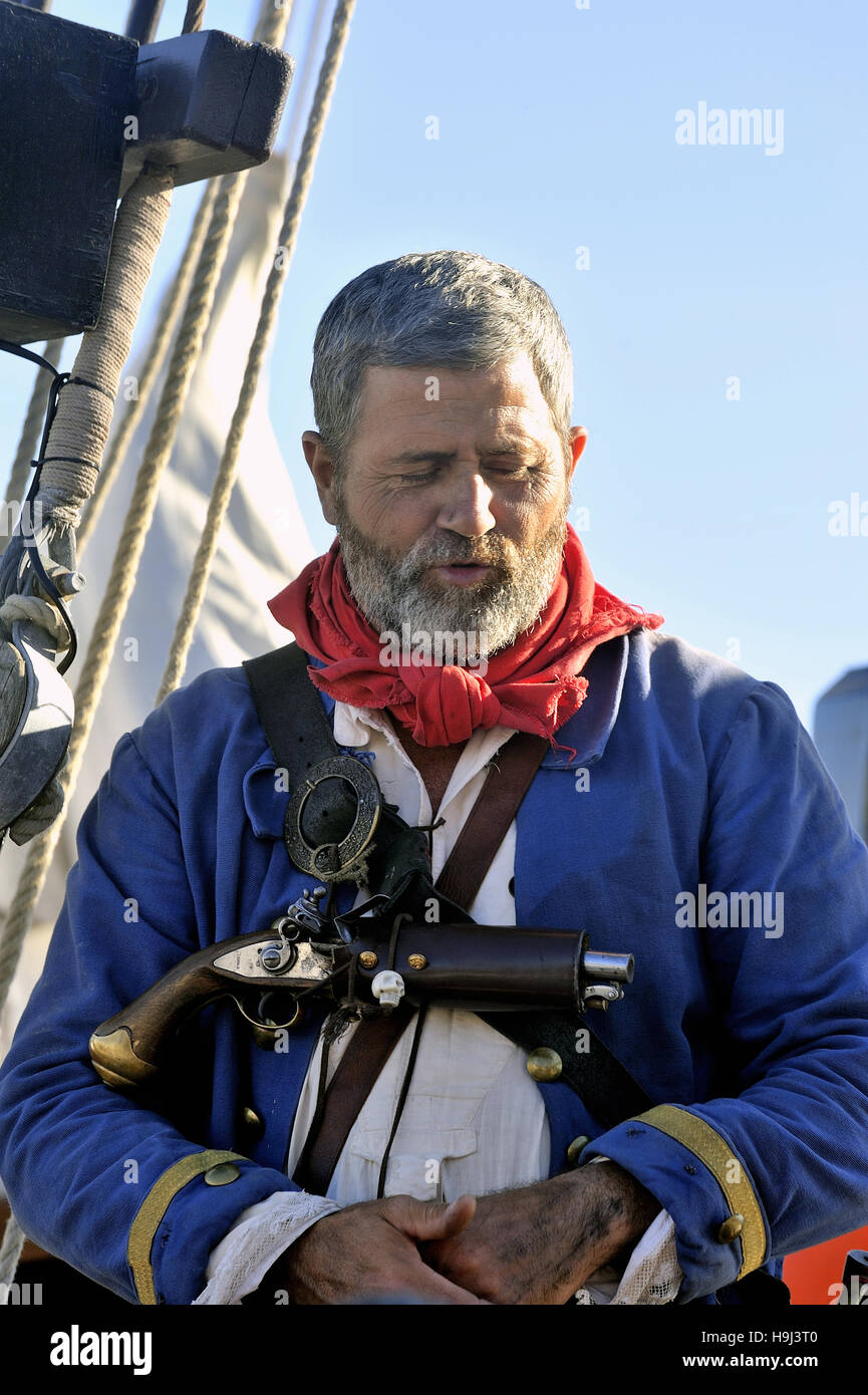 Sailor decorated with ancient garment on an old sailboat to explain to ...