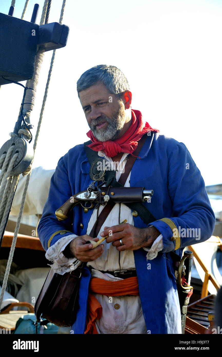 Sailor decorated with ancient garment on an old sailboat to explain to ...