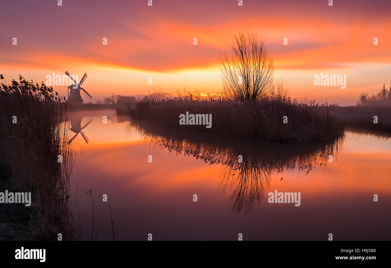 Reflection of a windmill at sunrise, Groningen Stock Photo - Alamy