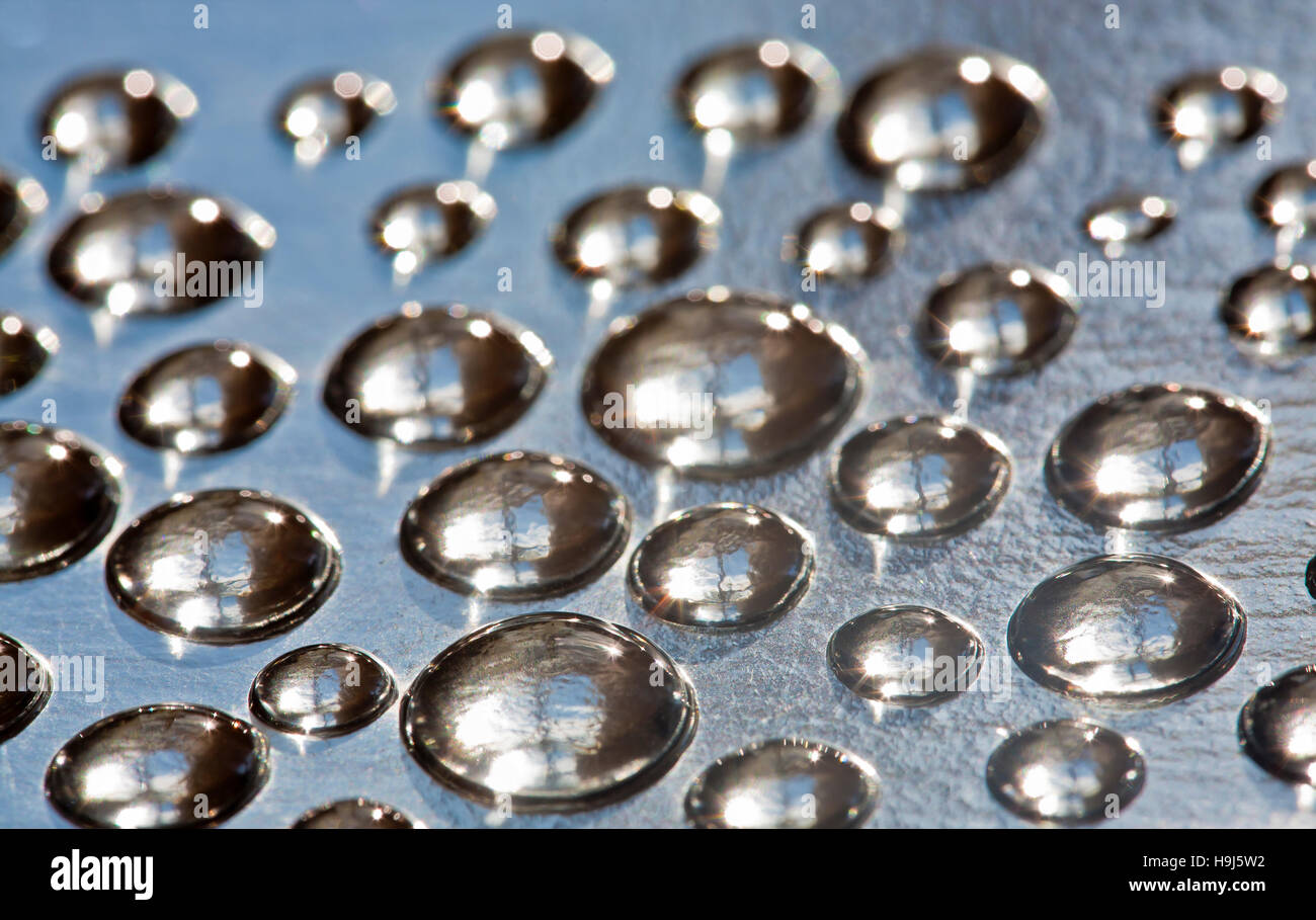 assorted sized water droplets on shiny textured surface Stock Photo - Alamy
