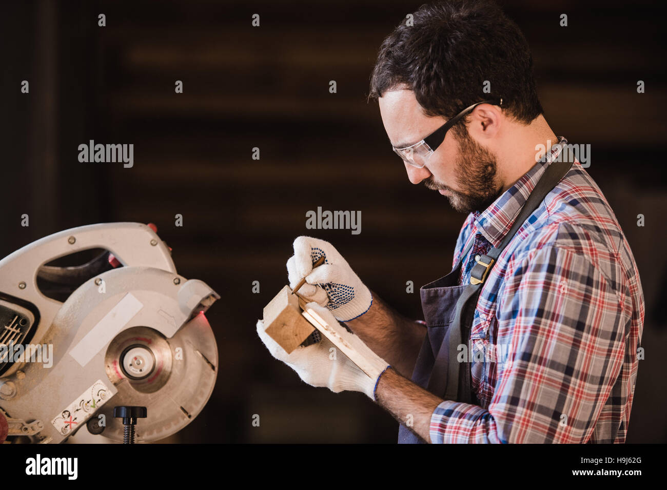 profession, carpentry, woodwork people concept - carpenter with wood ...