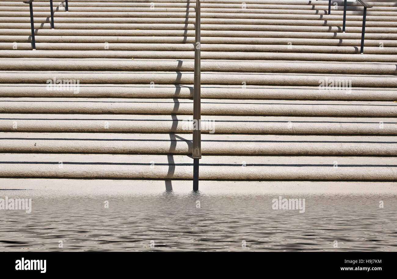 Concrete stairs and railings leading down to water Stock Photo - Alamy
