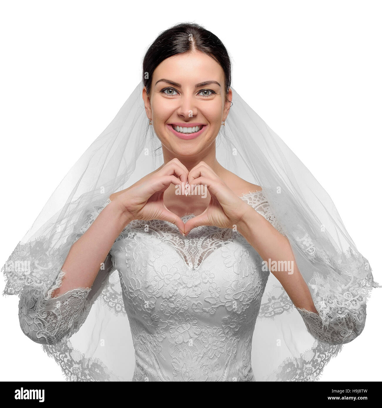 Female bride with hands shaping a heart symbol Stock Photo - Alamy
