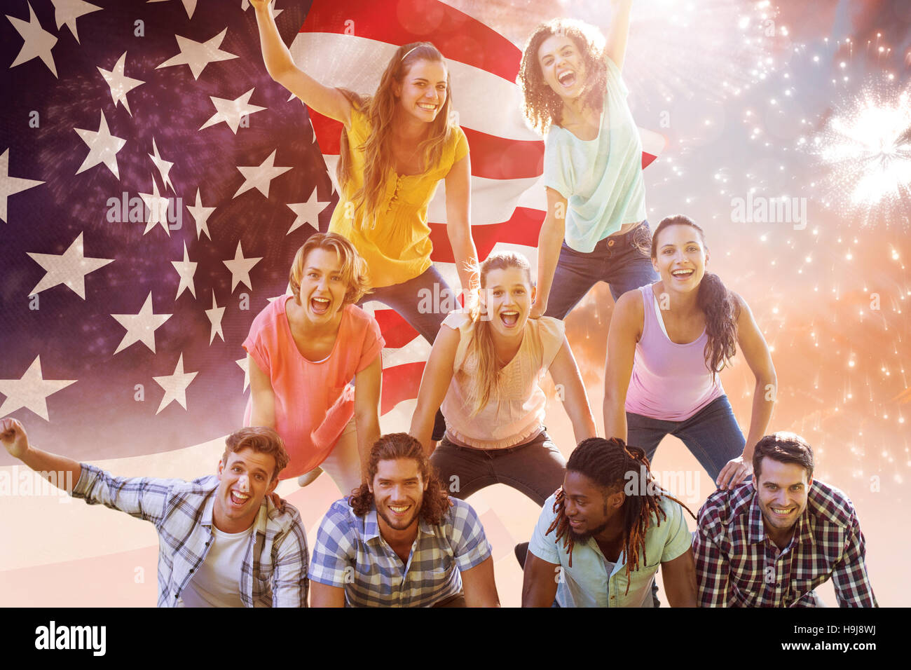 Composite image of happy friends in the park making human pyramid Stock ...