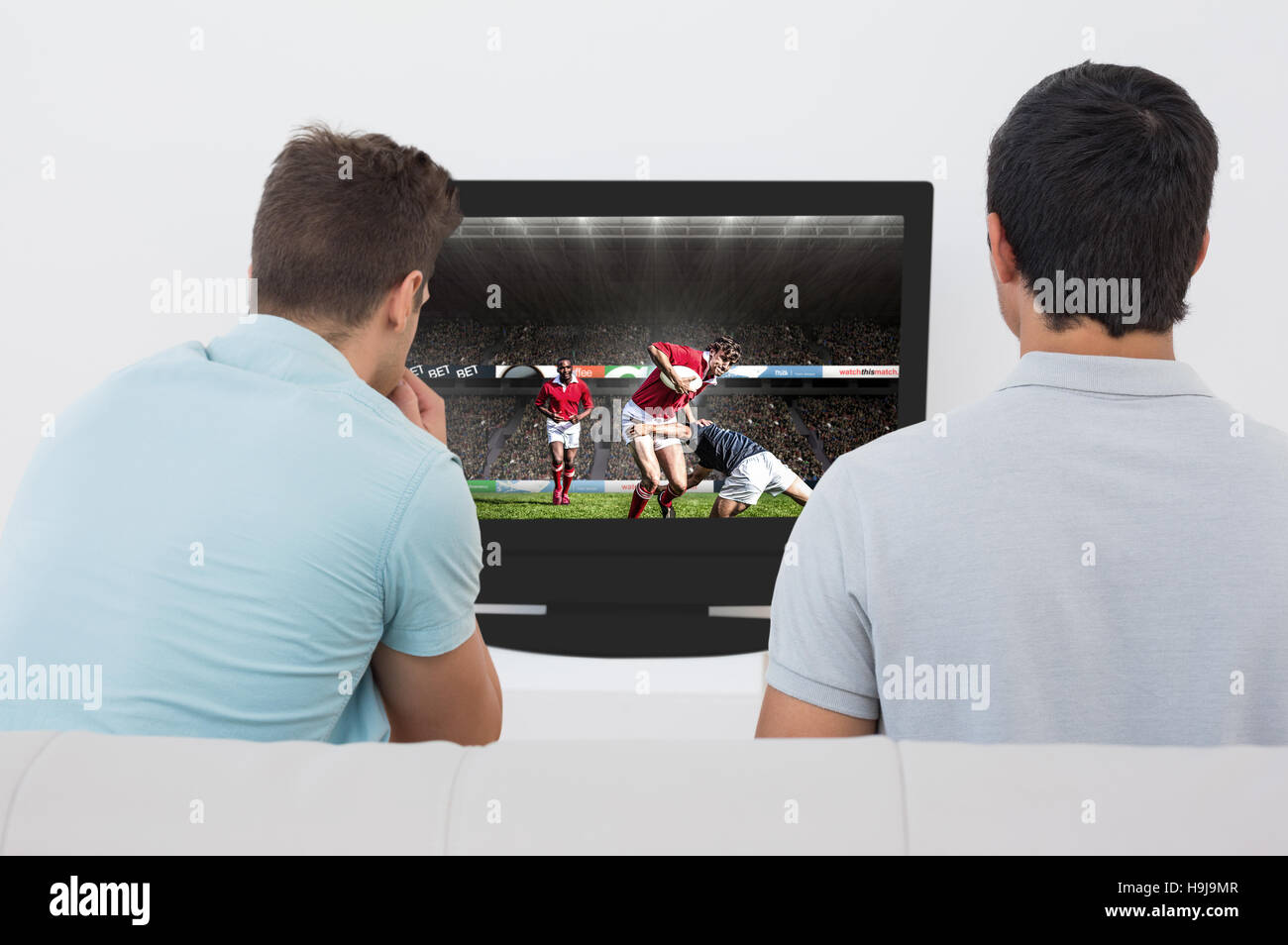 Two friends watching tv with football hi-res stock photography and ...