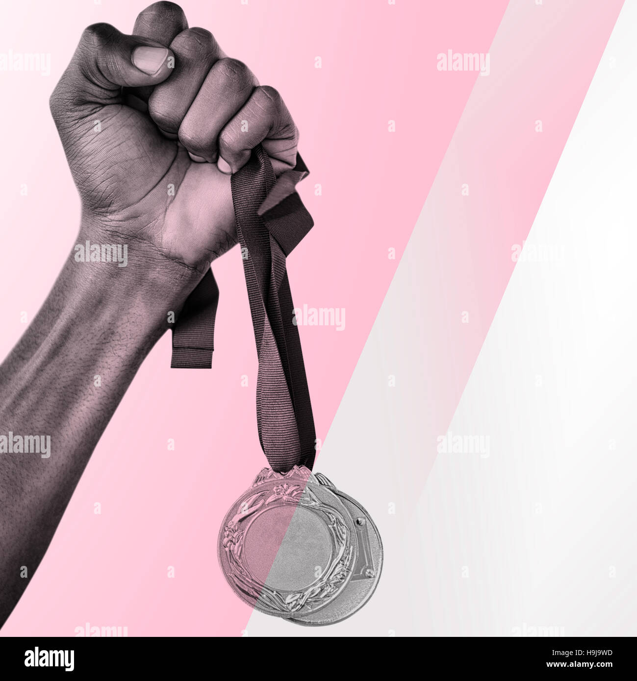 Composite image of hand holding two gold medals on white background ...